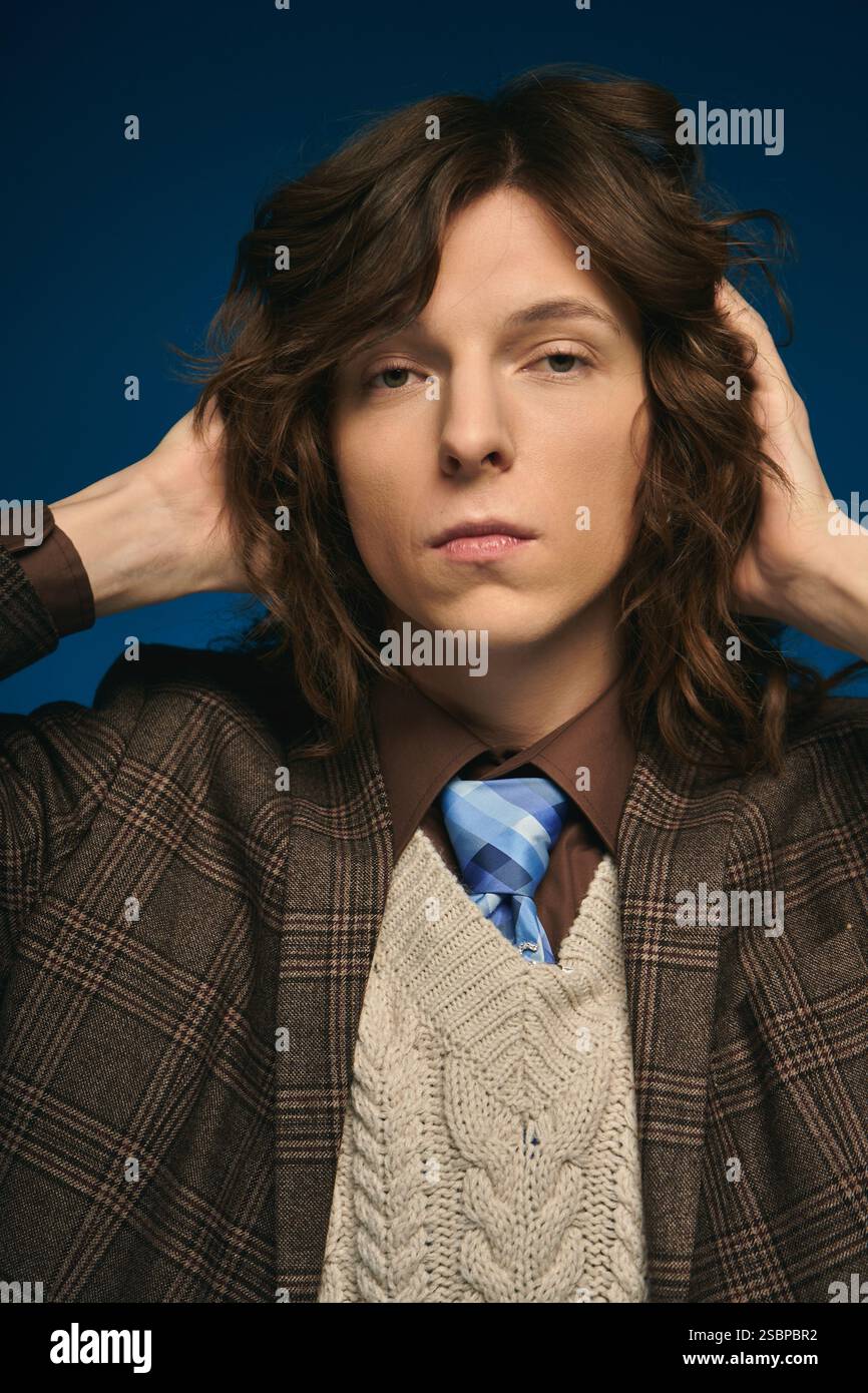 A handsome young man showcases his chic style with fashionable attire ...