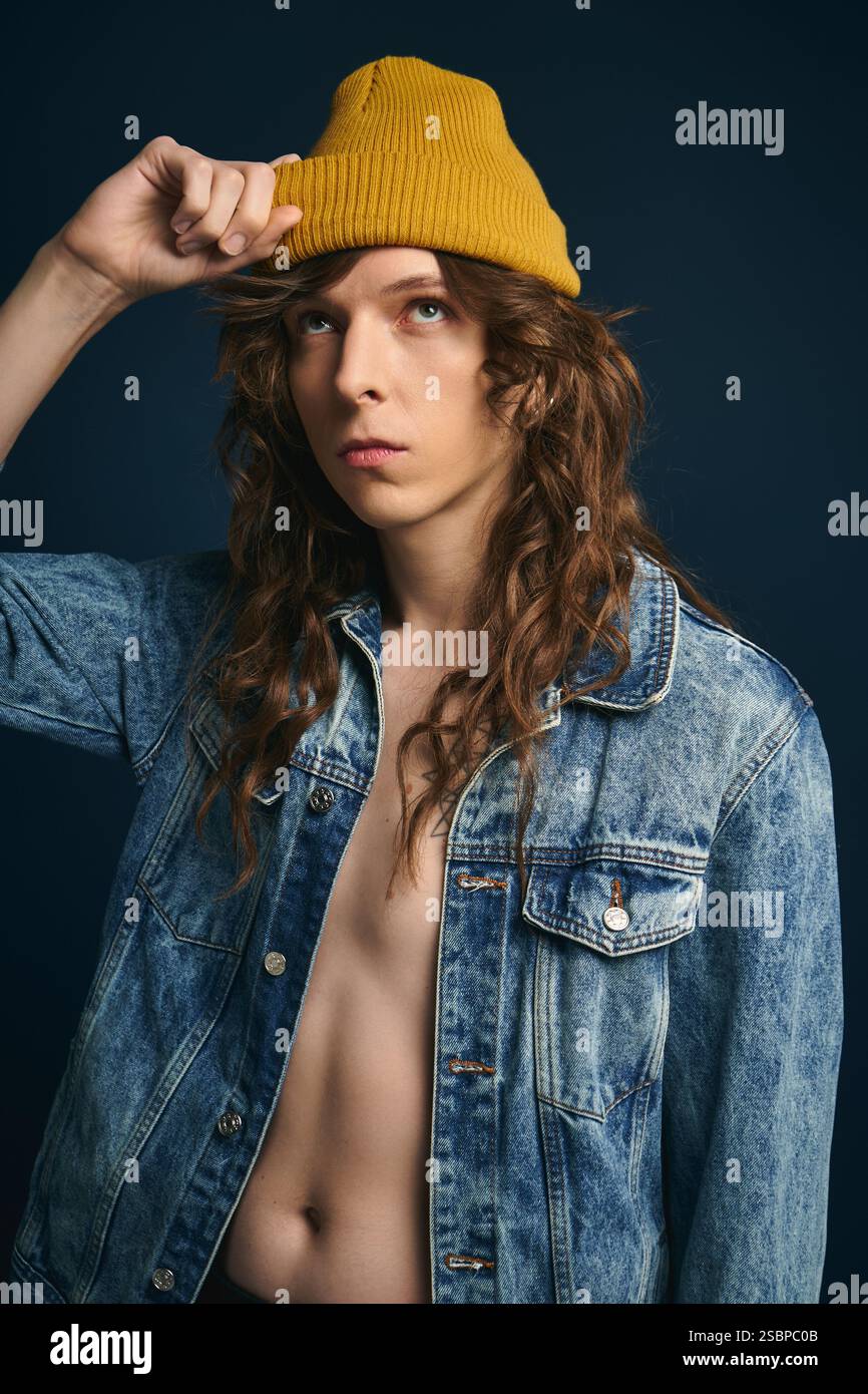 A handsome young man dons chic attire, striking a trendy pose with ...