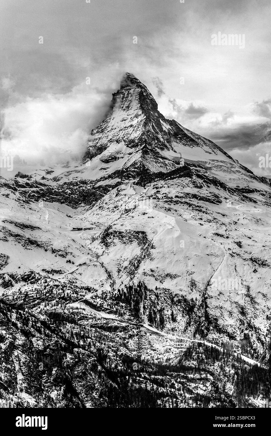 Clouds gather around the summit of the iconic, pyramidal Matterhorn ...