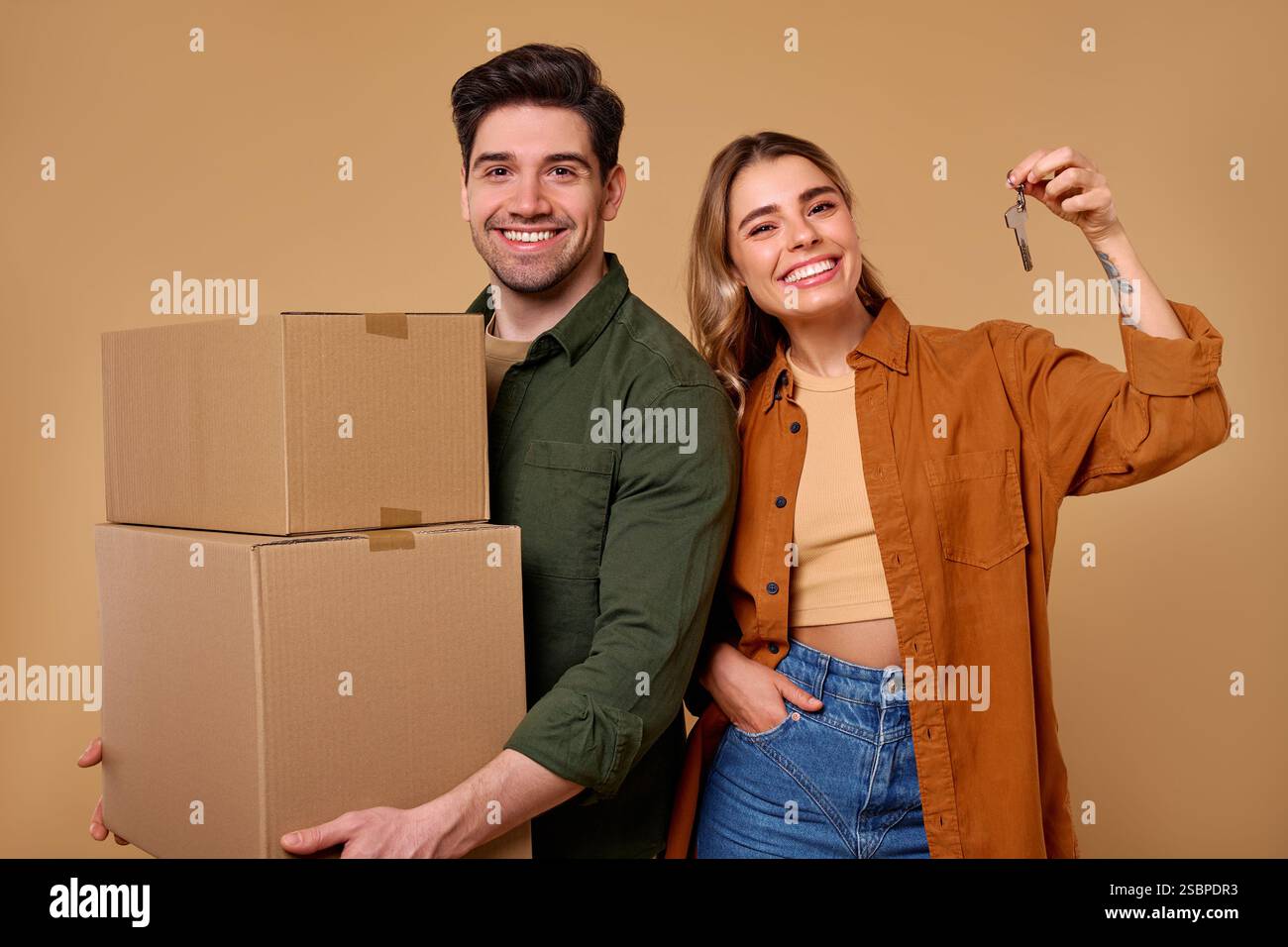 A joyful and happy young couple is celebrating their new home together ...