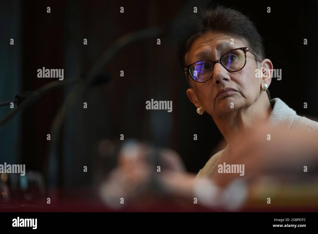 Professor Neena Modi, looks at a large screen as she takes part in a ...