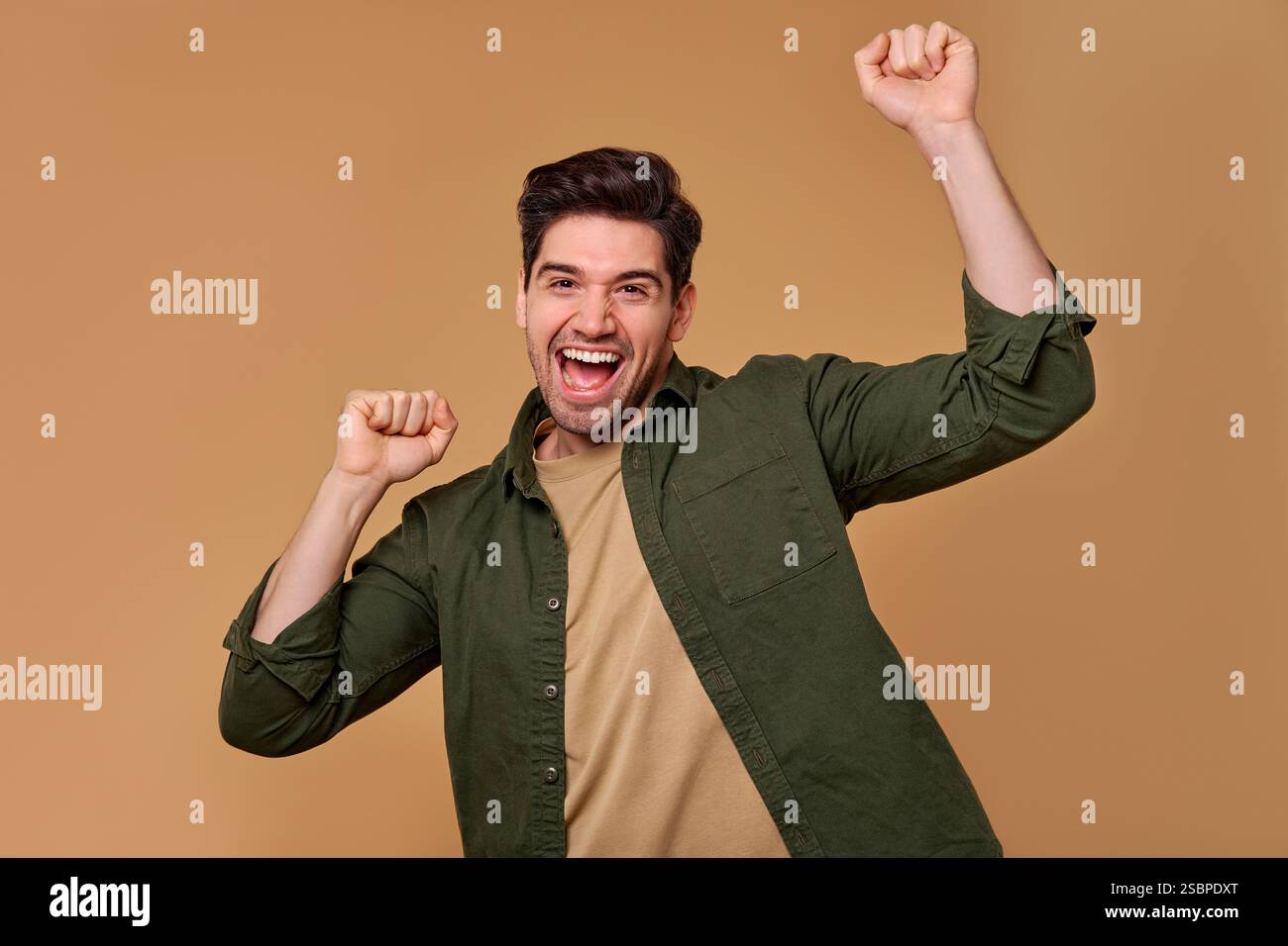 A cheerful young man radiating positivity and pure joy celebrates life ...