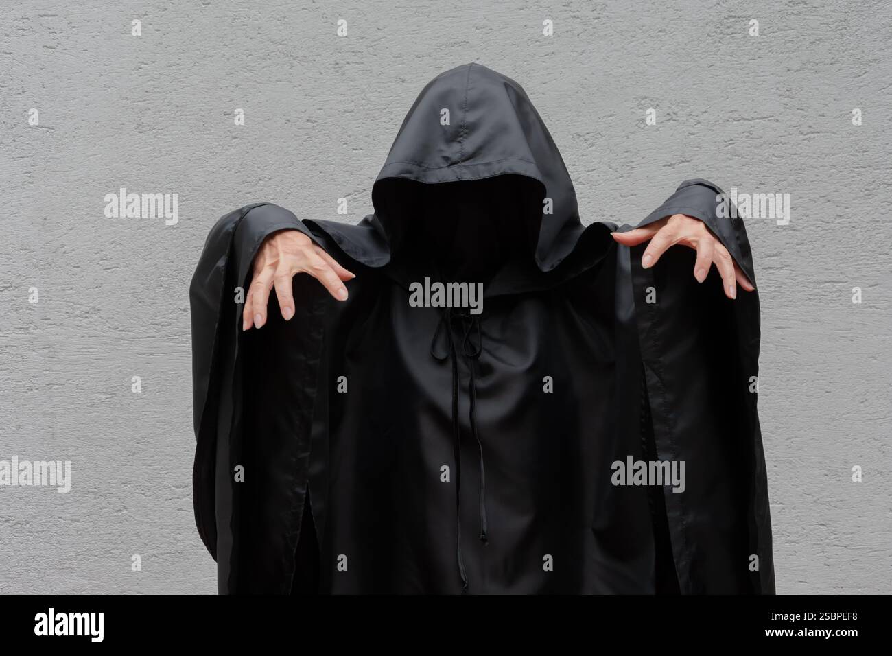 A mysterious man in a robe performs a magical ritual Stock Photo - Alamy