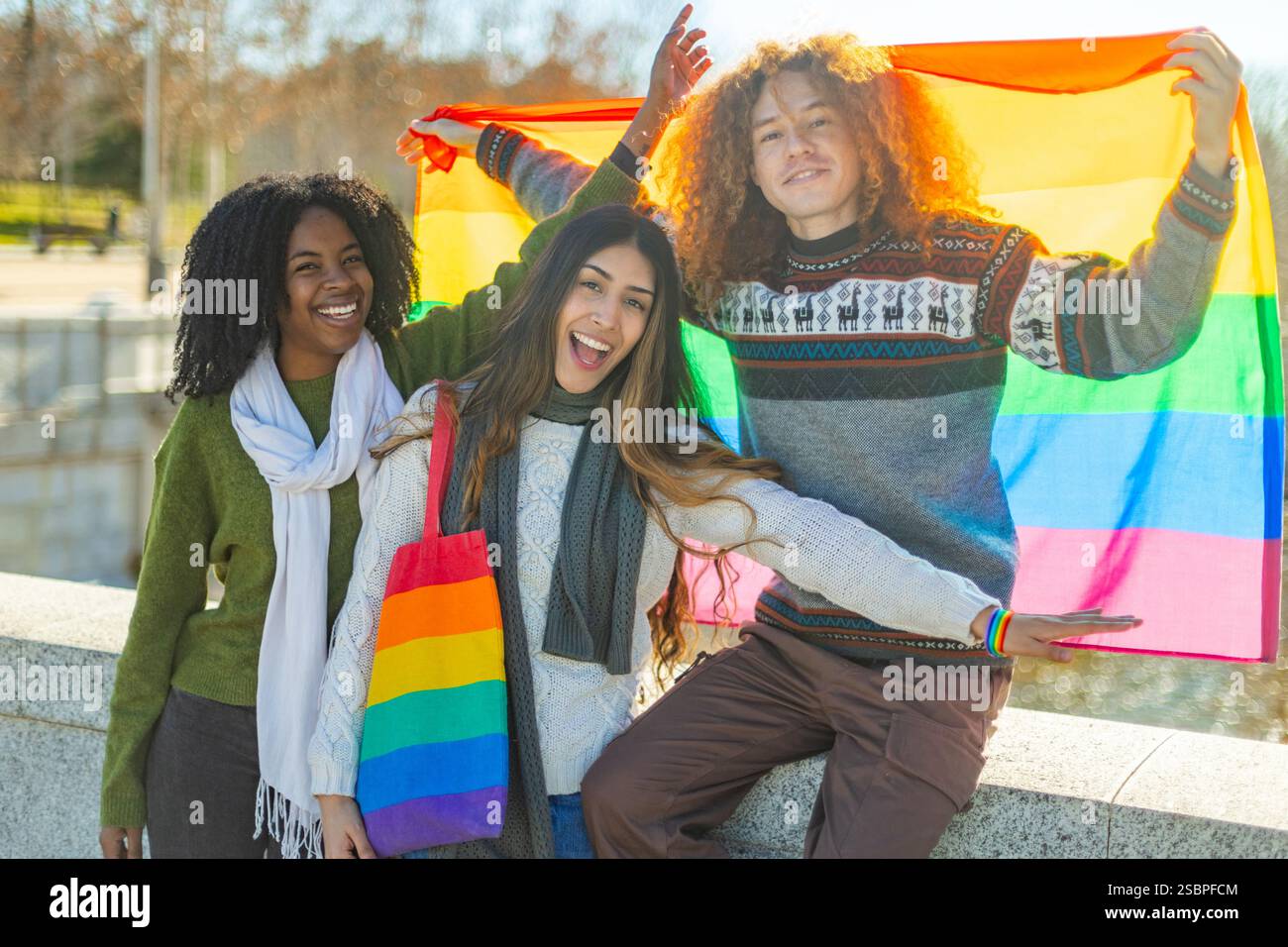 Happy multiethnic friends showing their support for lgbt rights with a ...