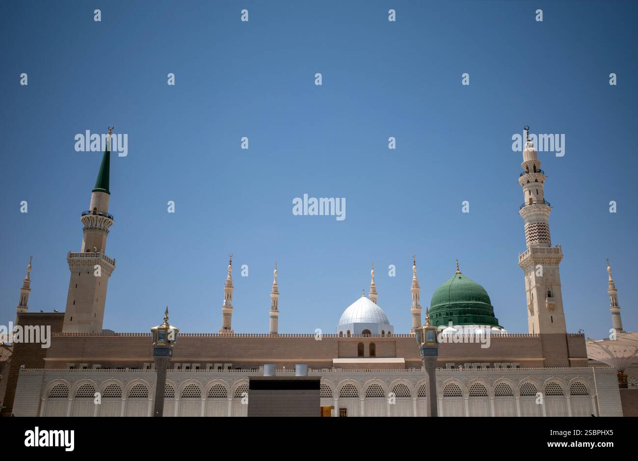 A green dome and minarets in Prophet Mosque in Madinah, also known as ...