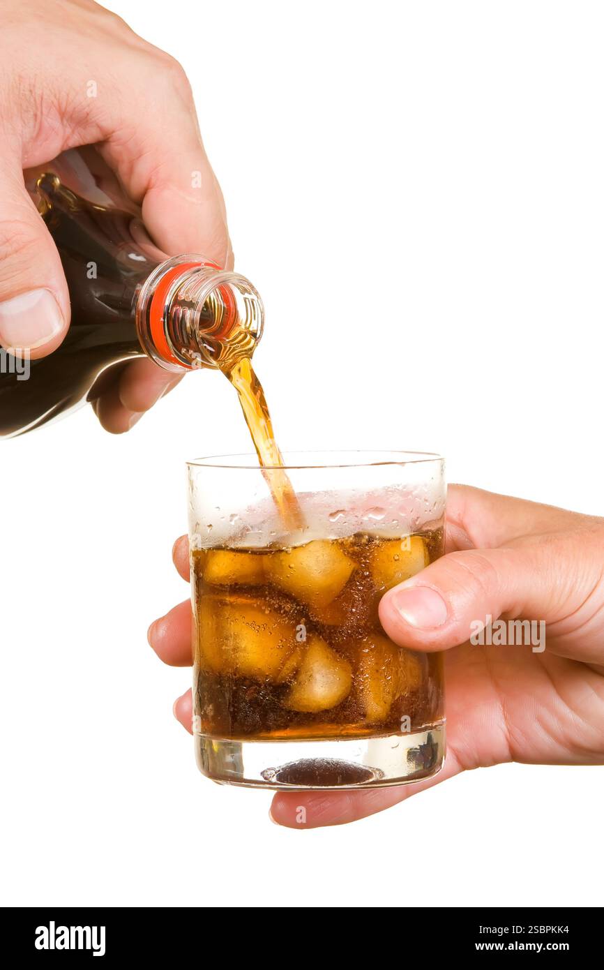 pouring soda into a glass isolated on white background Stock Photo - Alamy