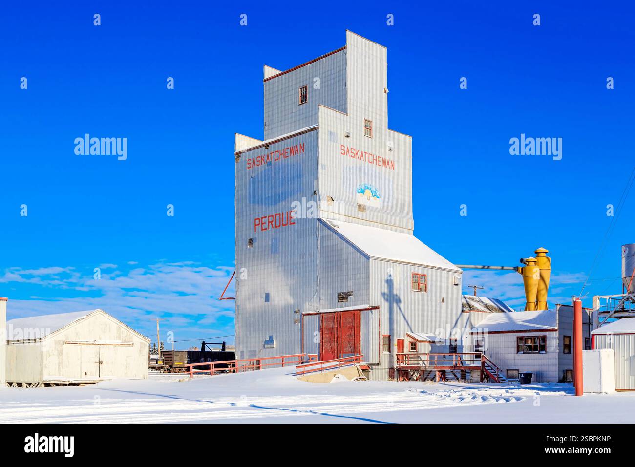 Large grain silo with the word PERI on it. The silo is surrounded by ...