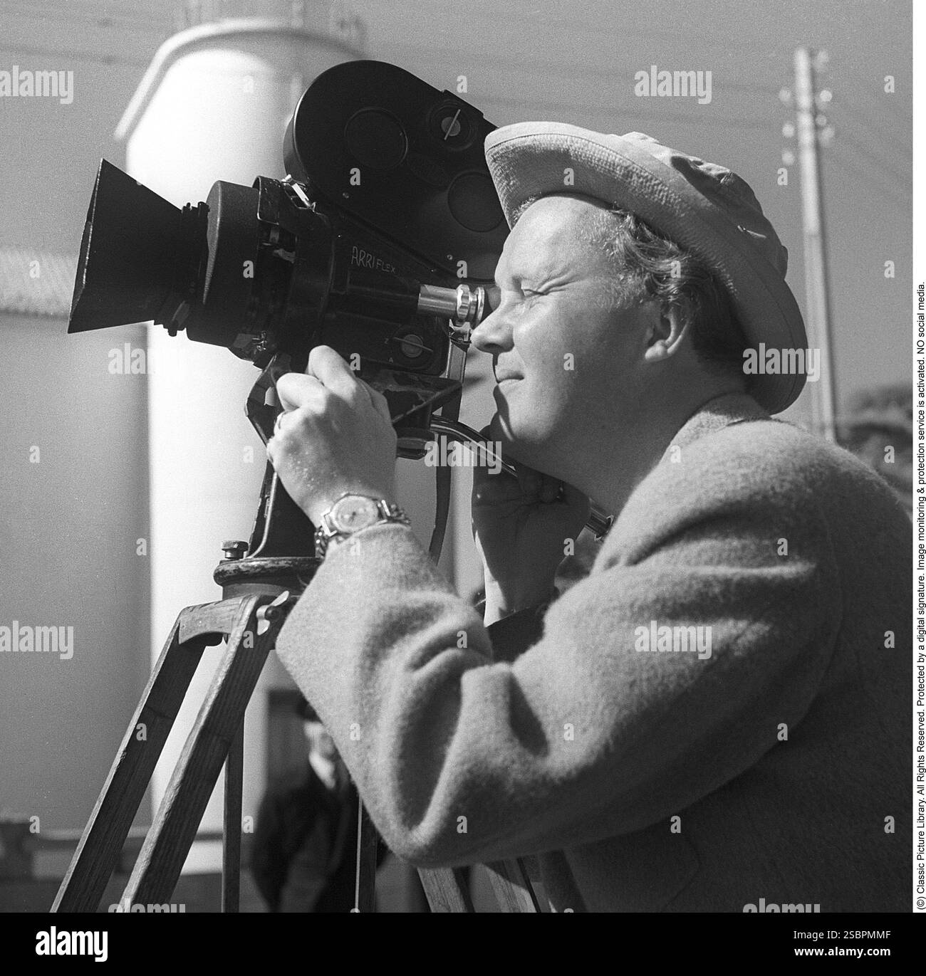 Filming in the 1940s. A cinematographer with his camera as he films ...