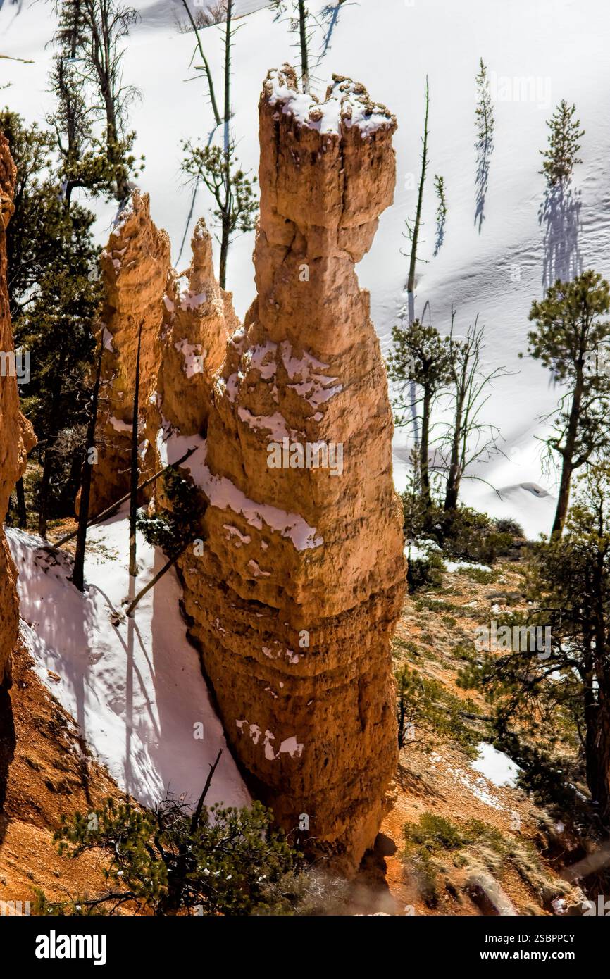 A large rock formation covered in snow. The snow is white and the rock ...