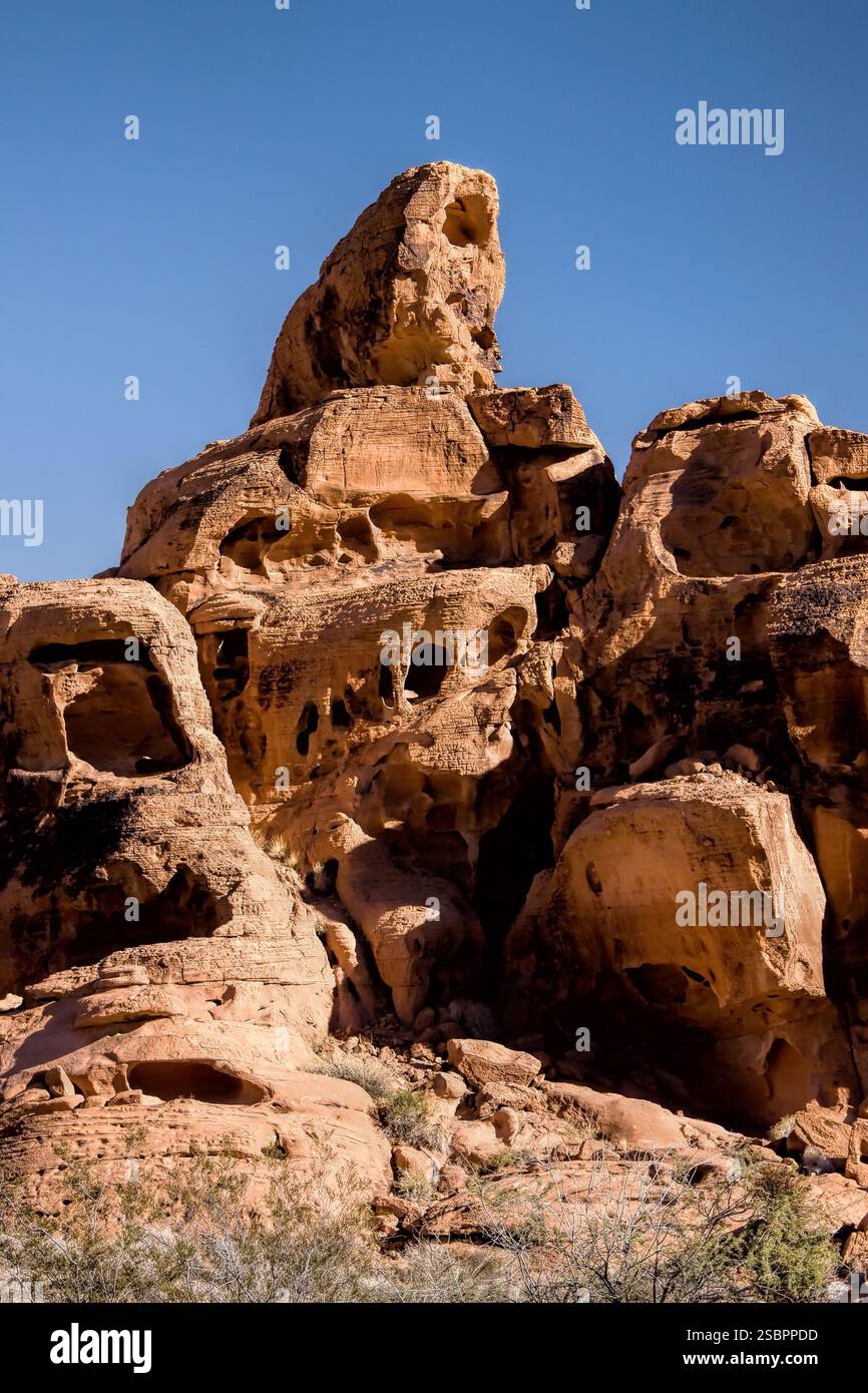 A large rock formation with many holes in it. The holes are small and ...