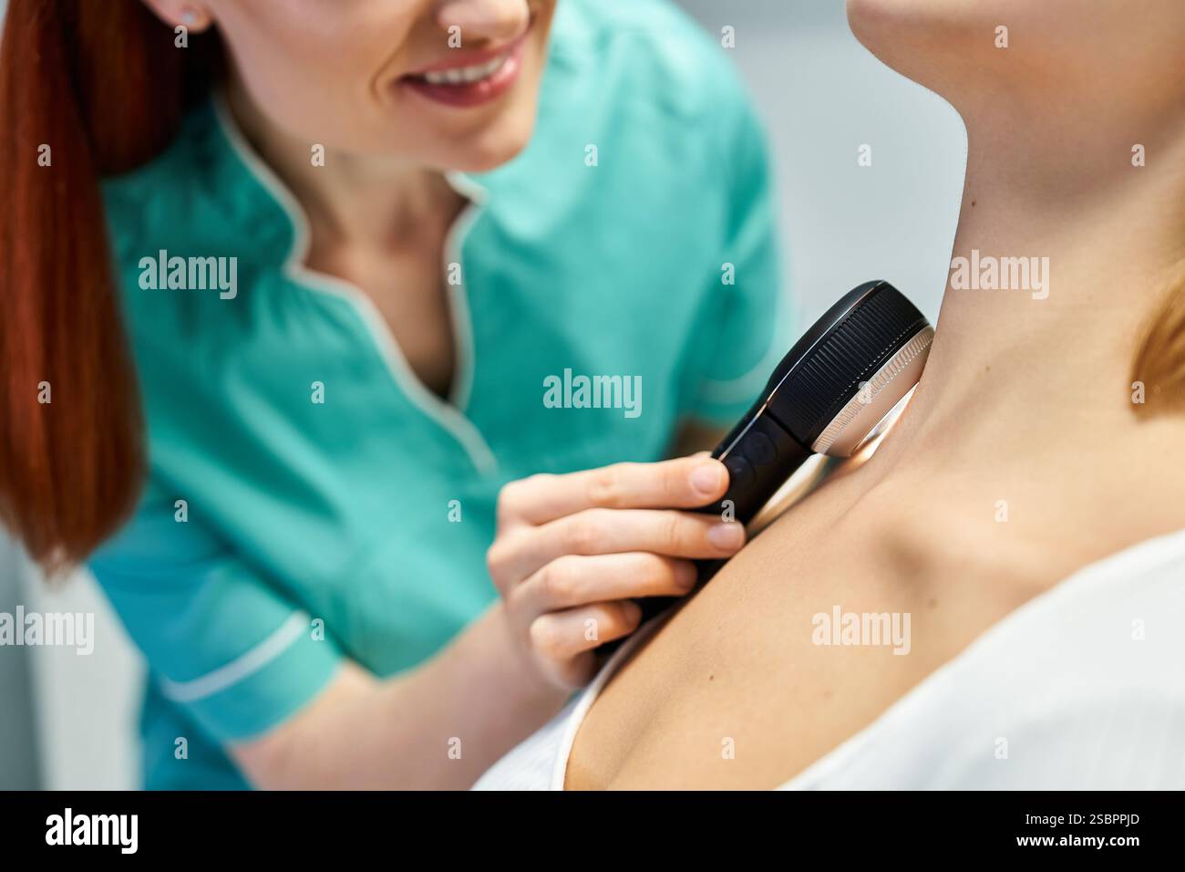 A skilled dermatologist examines a patients skin with a magnifying ...