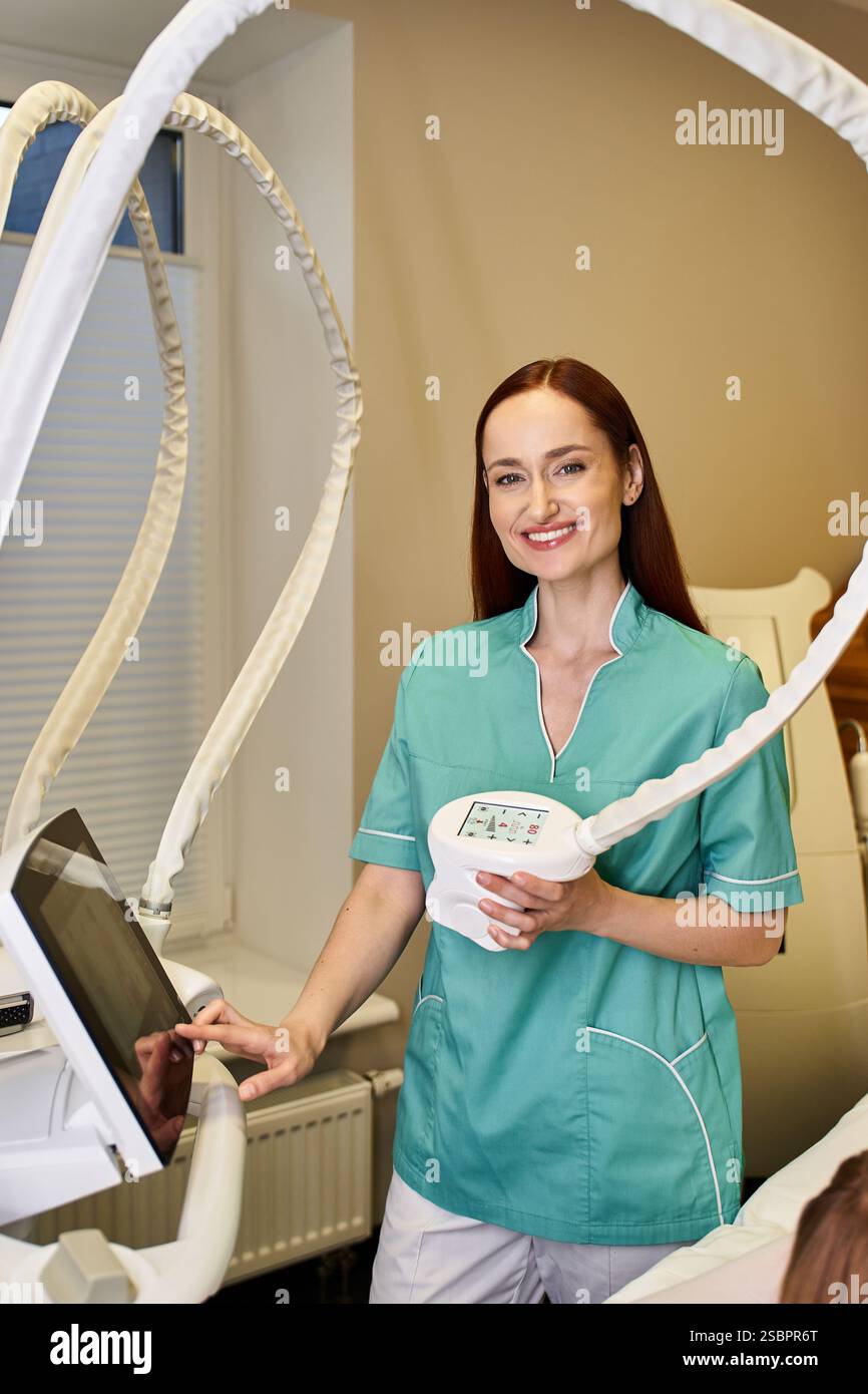 A young, beautiful dermatologist smiles while operating advanced ...