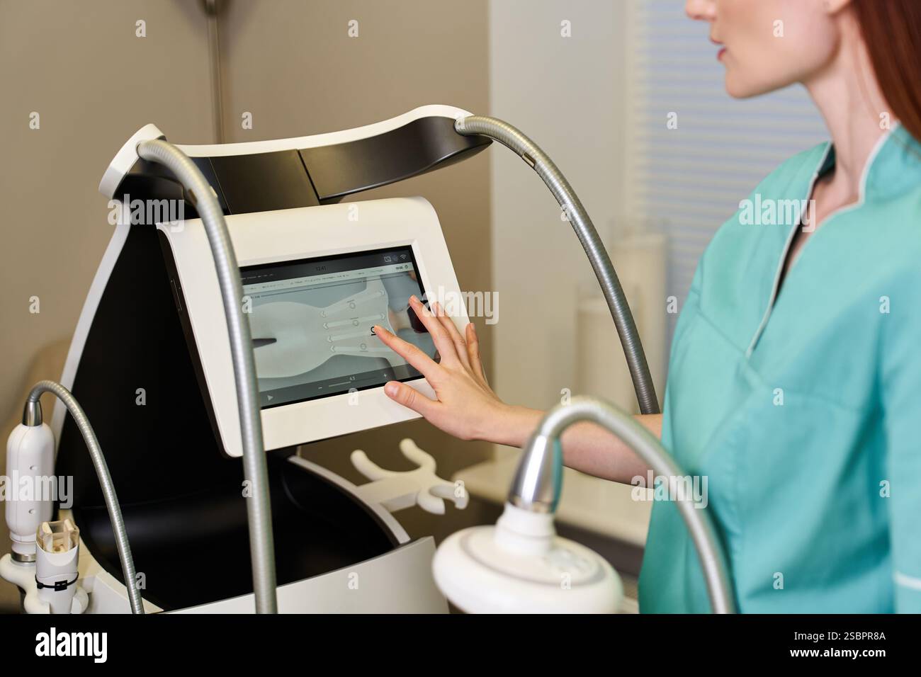 A young dermatologist uses equipment for a skin treatment session Stock ...