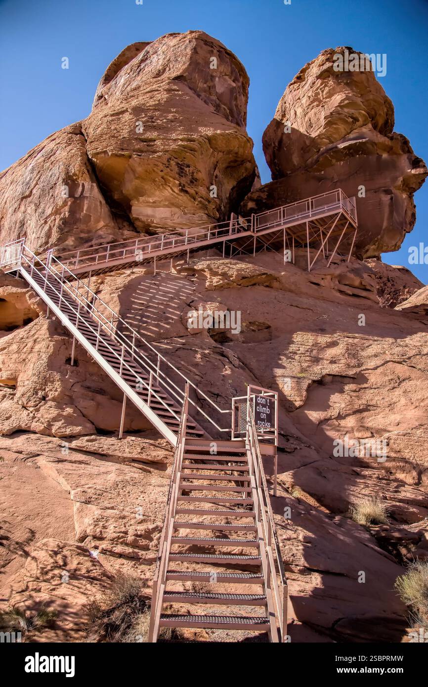 A rock wall with a staircase leading up to it. The stairs are made of ...