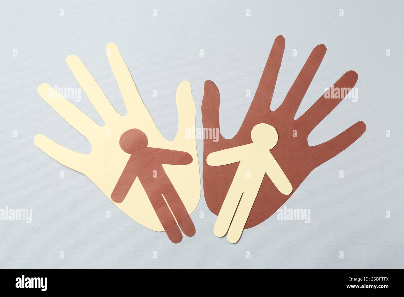 Stop racism. Hands and human paper figures of different colors on light ...