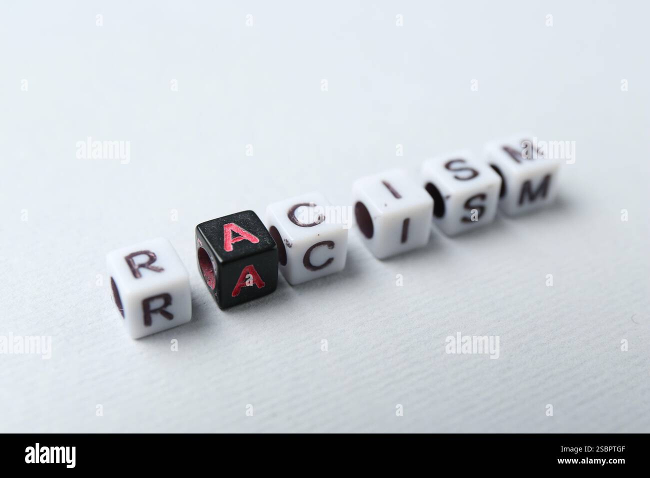 Word Racism made with beads on light grey background, closeup Stock ...