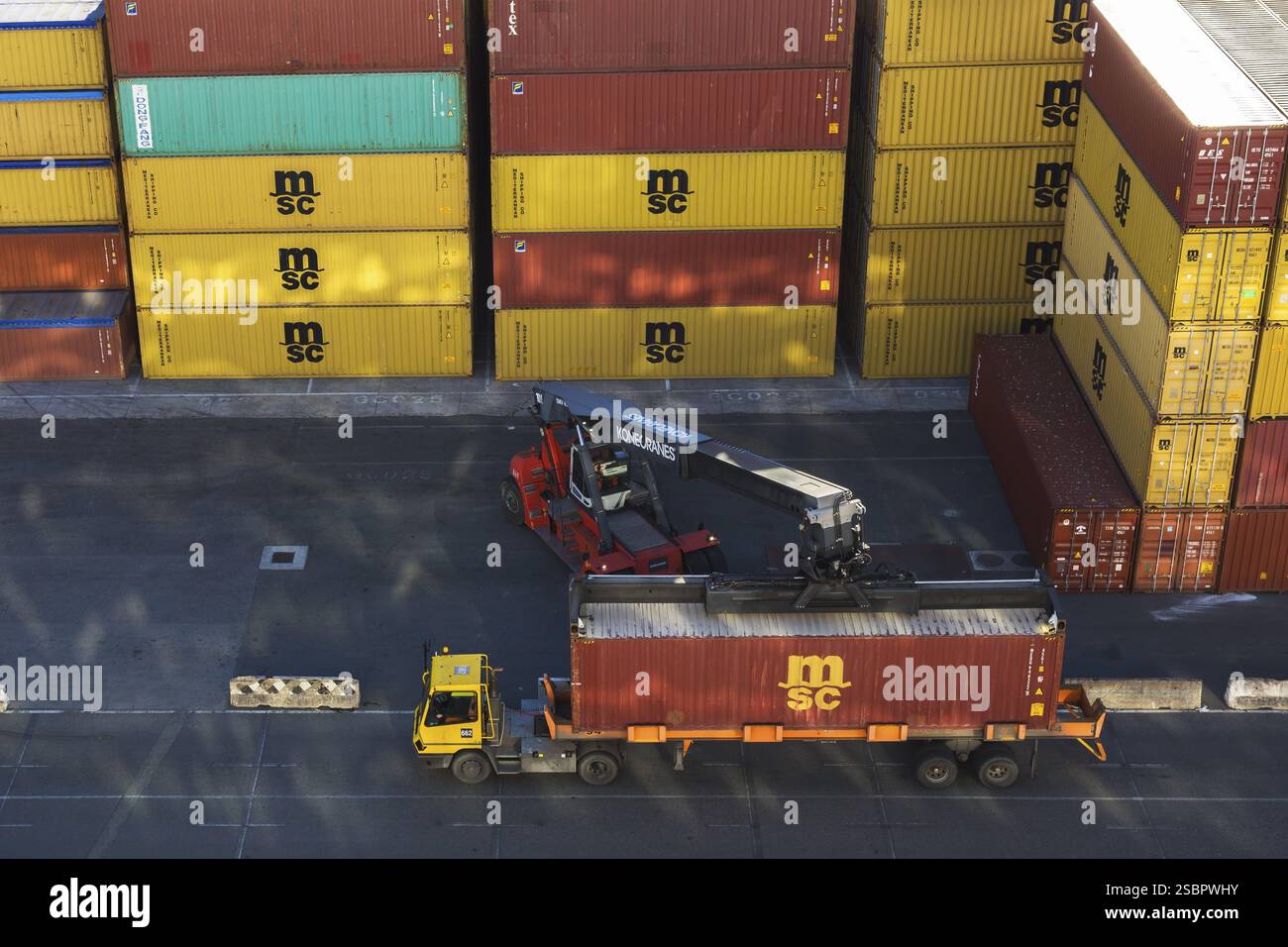 Kone Cranes container handler loading rectangular metal box shipping ...