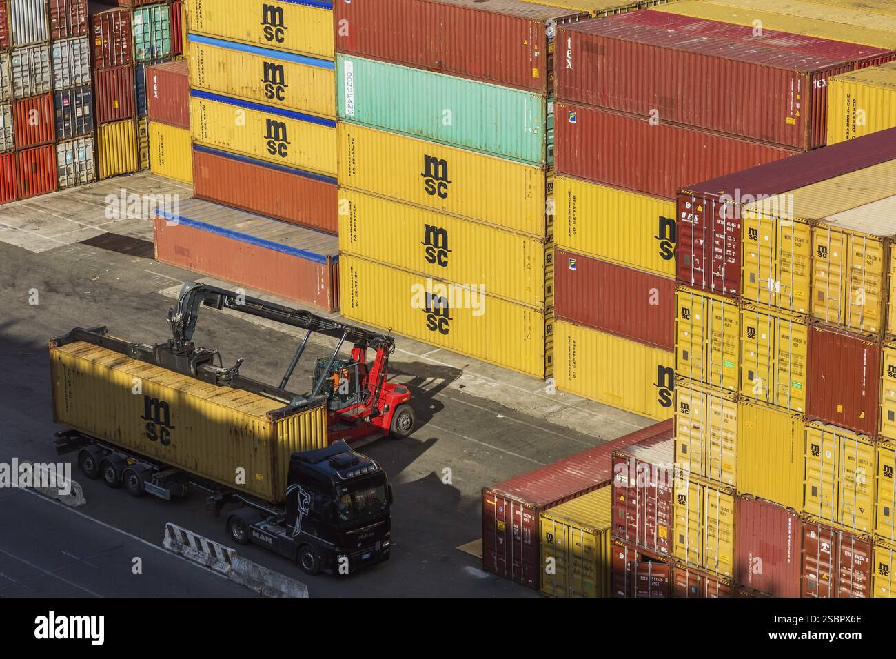 Top view of container handler loading rectangular metal box container ...