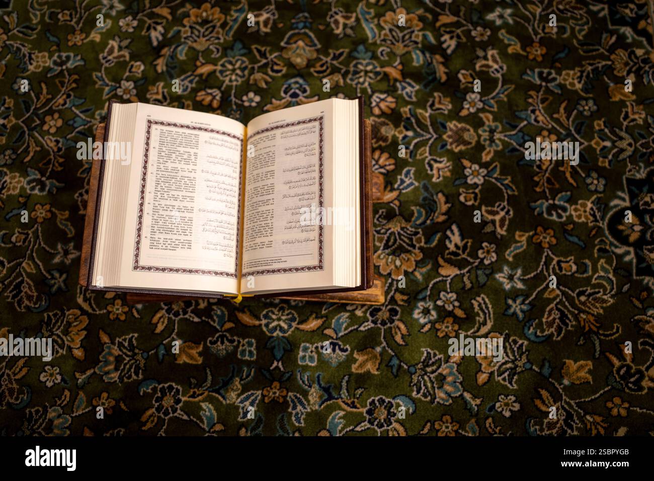 The holy book of the Quran is opened on a green carpet at the Prophet ...