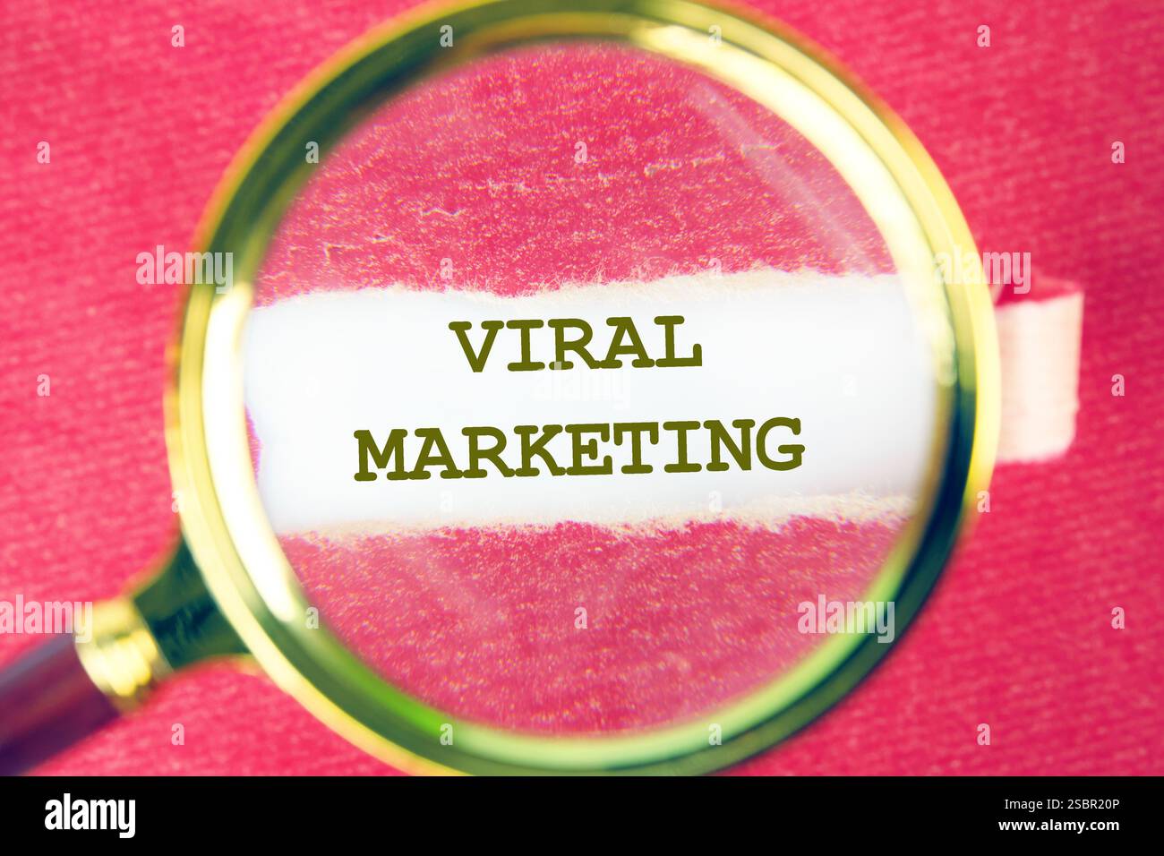 A magnifying glass focuses on the term viral marketing, highlighting ...