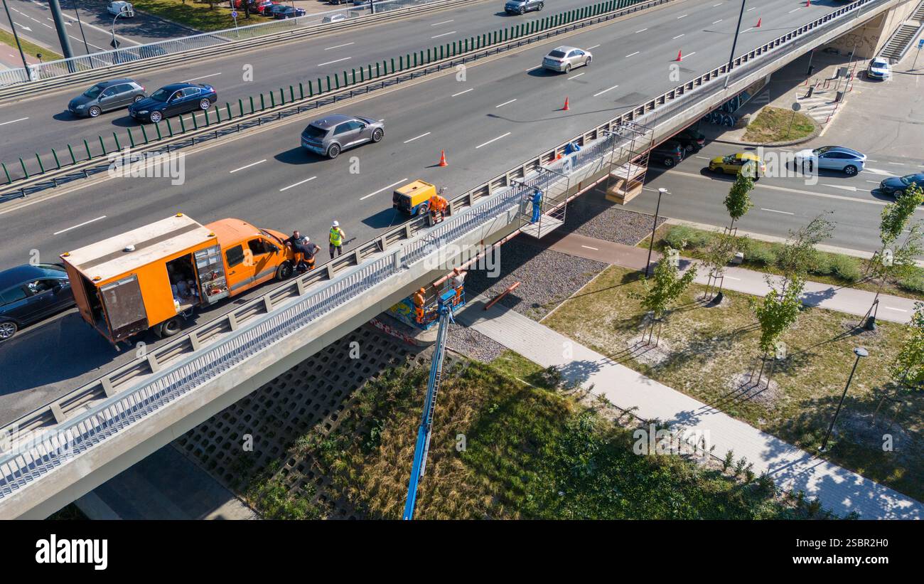Aerial view of a highway bridge under maintenance with workers and ...