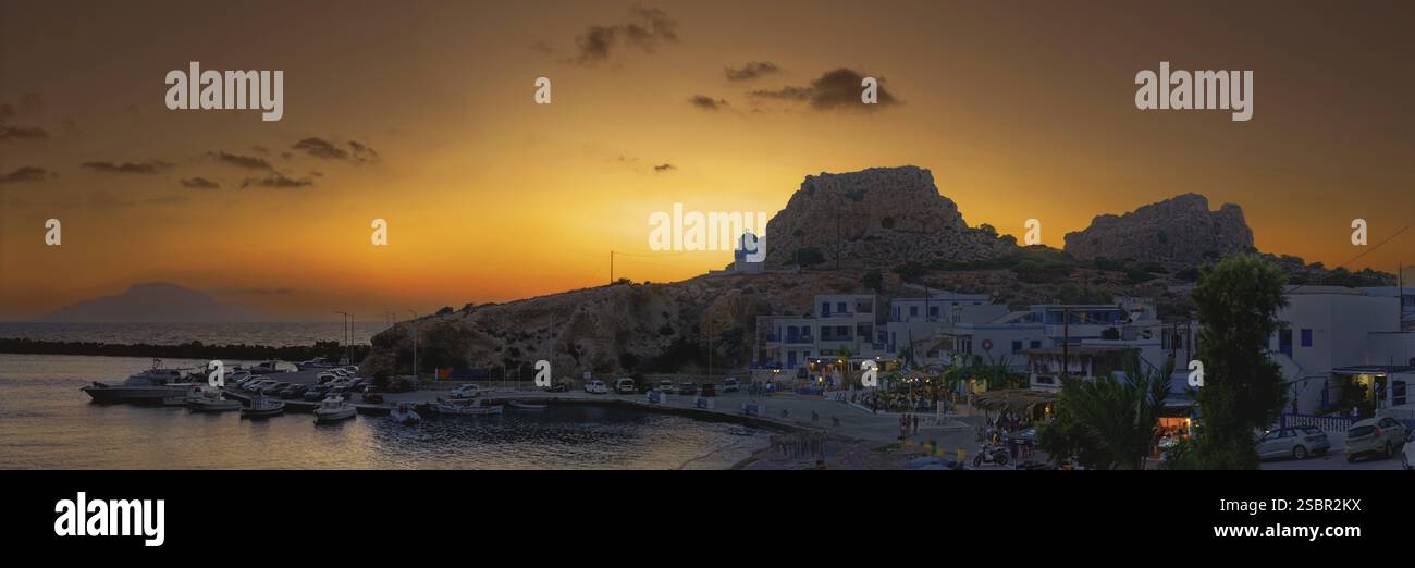 Harbour of the fishing village Finiki at dusk with boats and rocks ...