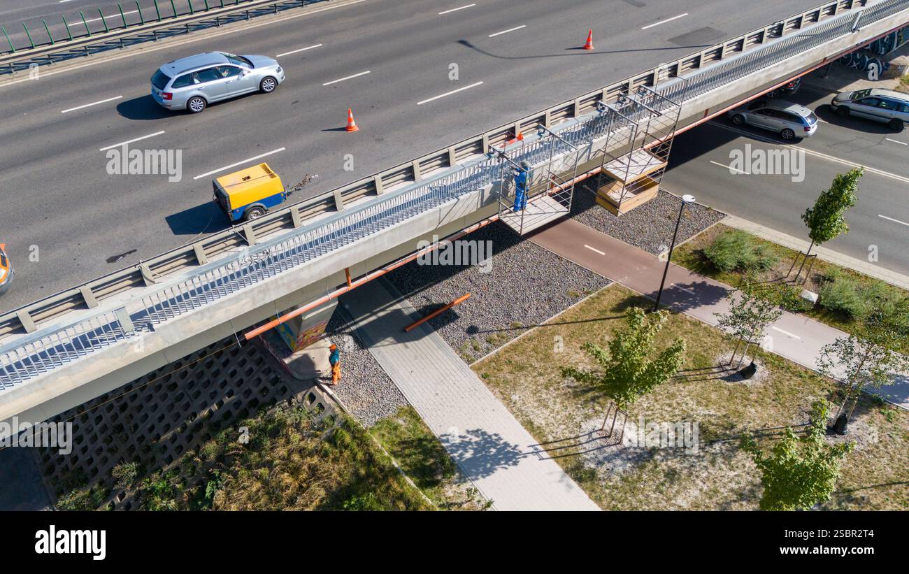 Aerial view of a highway bridge under maintenance with workers and ...