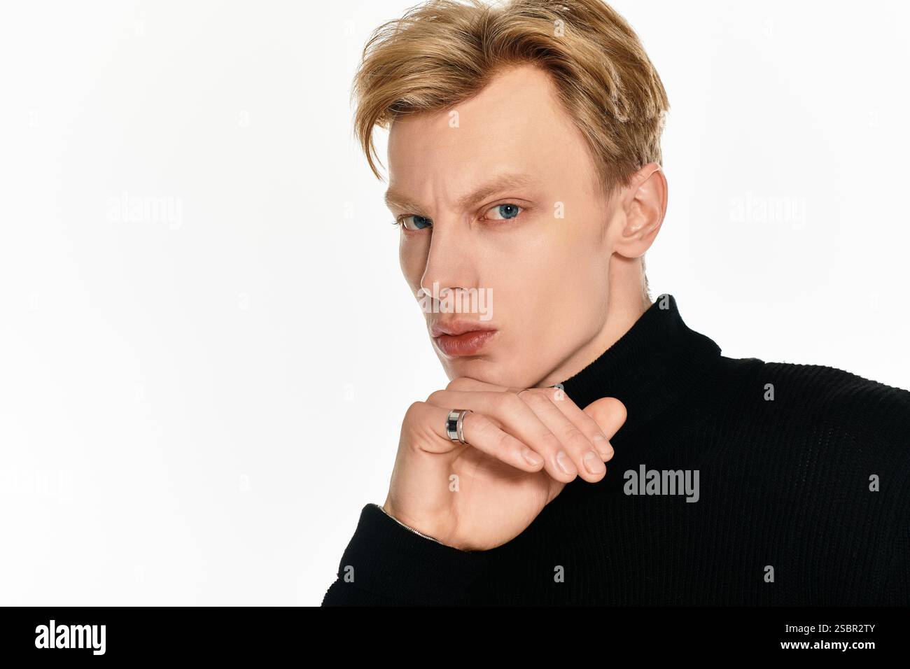 A young handsome man poses confidently, showcasing his striking ...