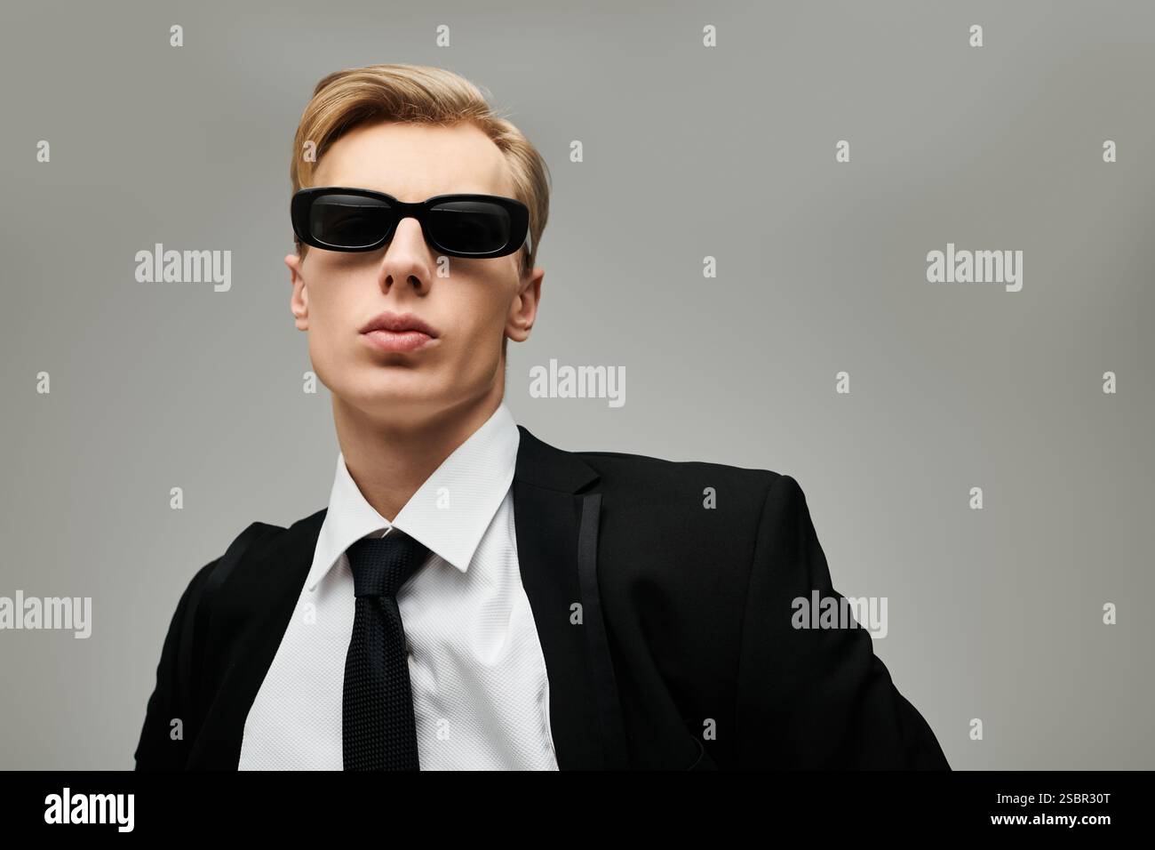 A young man dressed in a formal suit captures attention with his bold ...