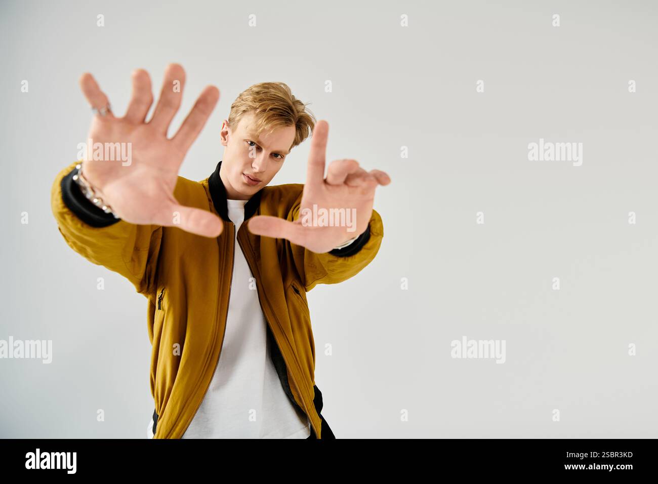 A young man showcases charisma and style with an engaging pose ...
