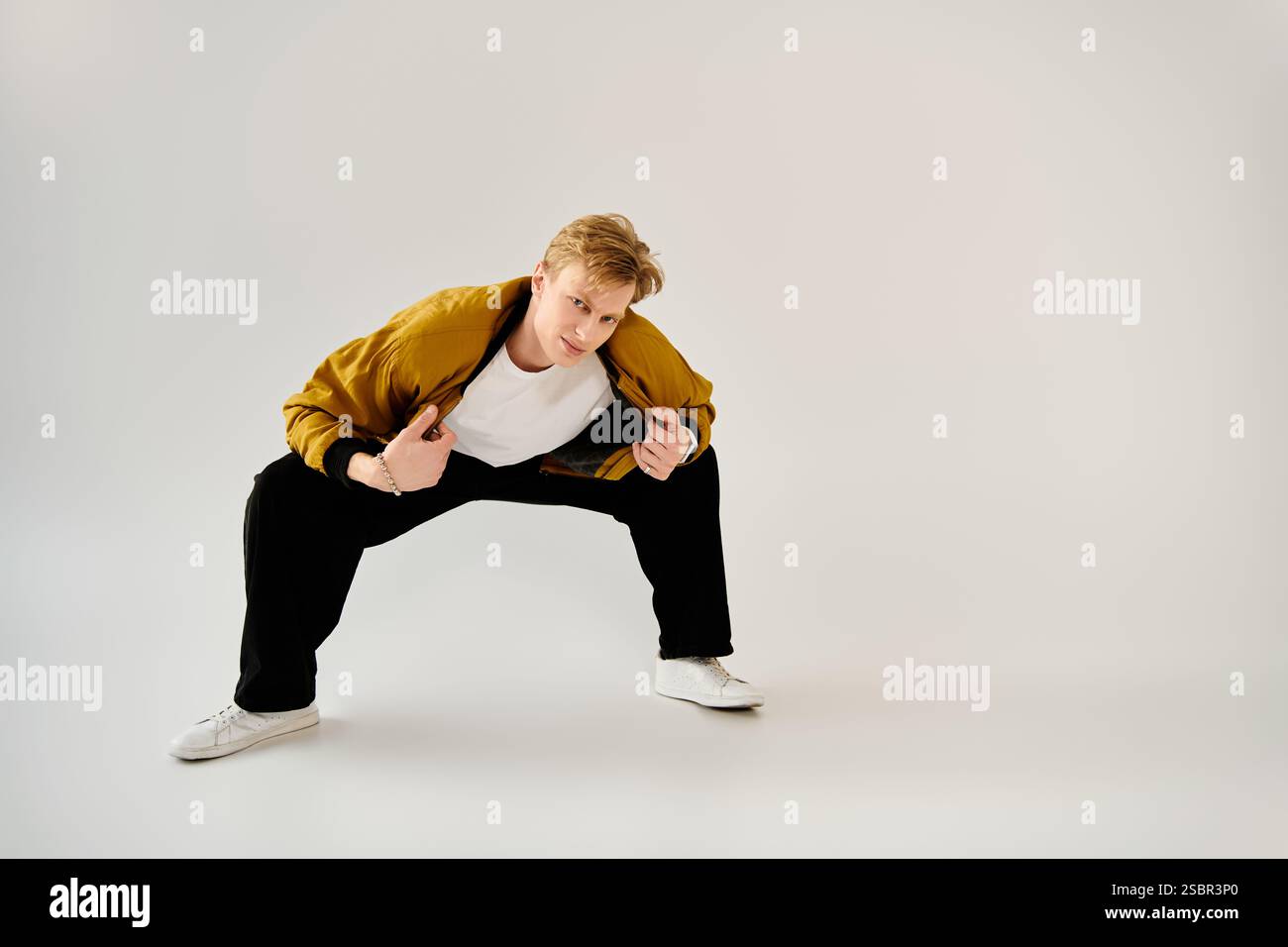 A young man showcases his unique style while confidently posing in ...