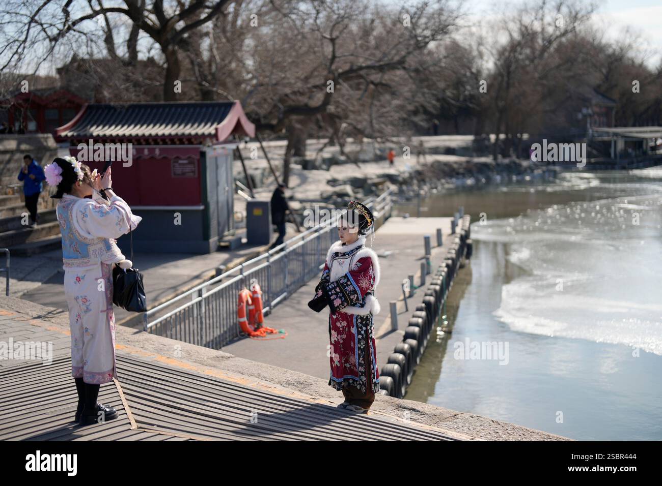 Women in traditional dress take pictures at the Summer Palace in ...