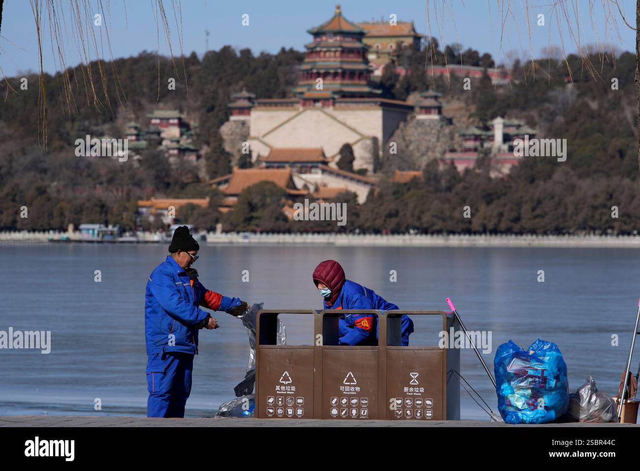 Workers collect garbage at the Summer Palace in Beijing on Tuesday, Feb ...