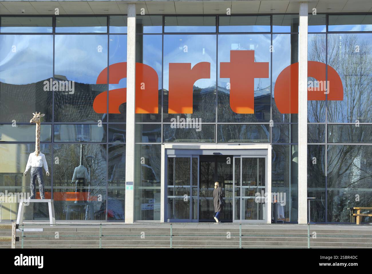 Entrance to the modern building of the broadcasting station Arte of ARD and ZDF with sculpture ...