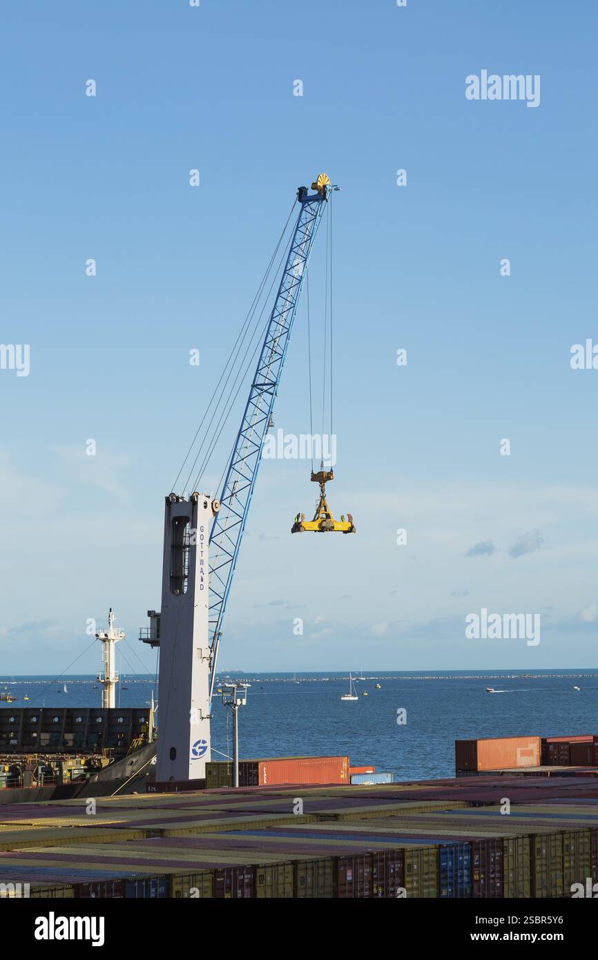 Gotwald crane with lifting attachment and stacked rectangular metal box ...