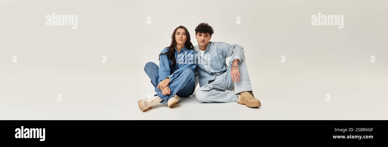 Stylish young duo sitting together, displaying the latest in ...