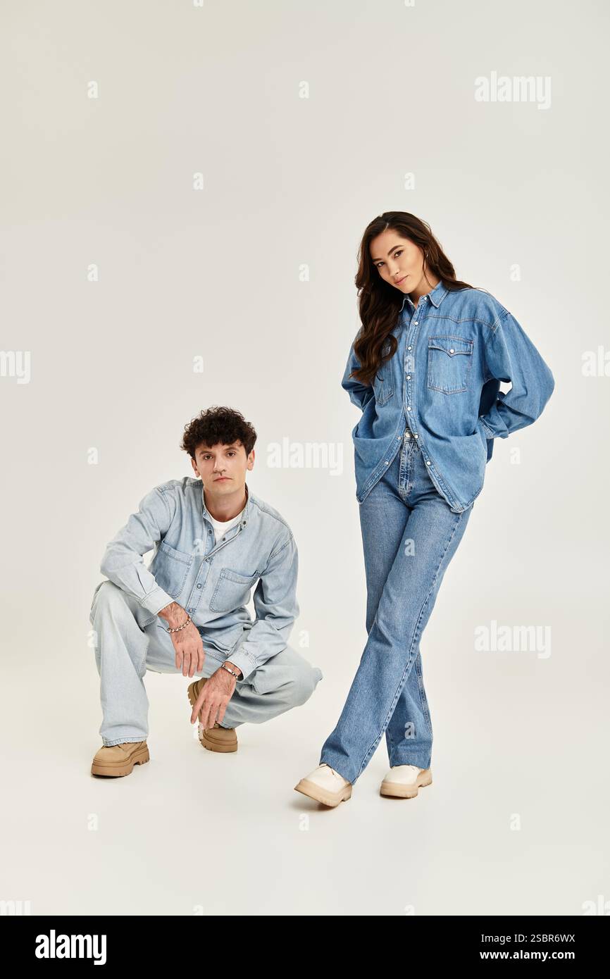 Trendy duo in coordinated denim outfits poses confidently against a ...