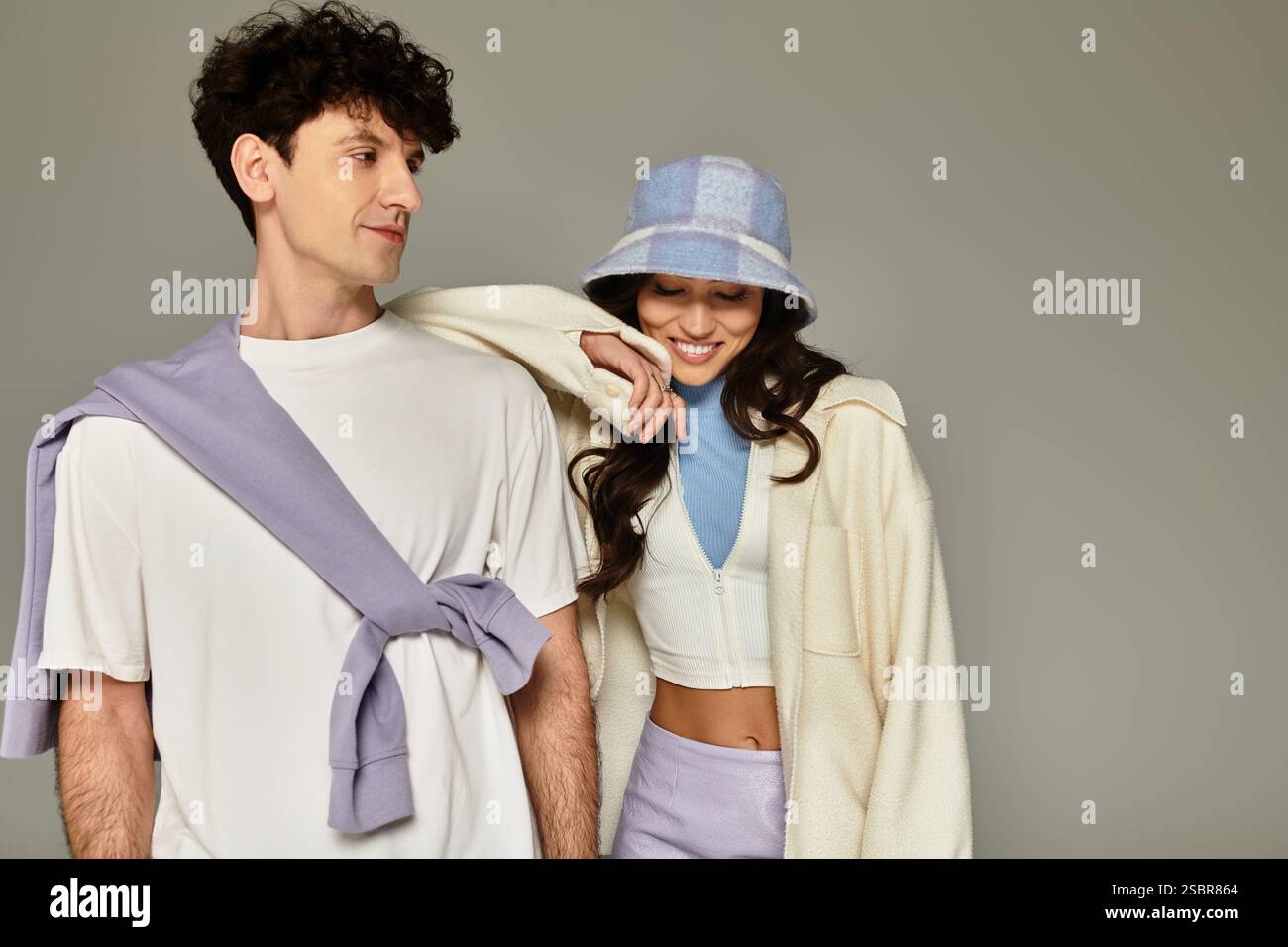 A stylish duo showcases trendy outfits in a chic studio Stock Photo - Alamy