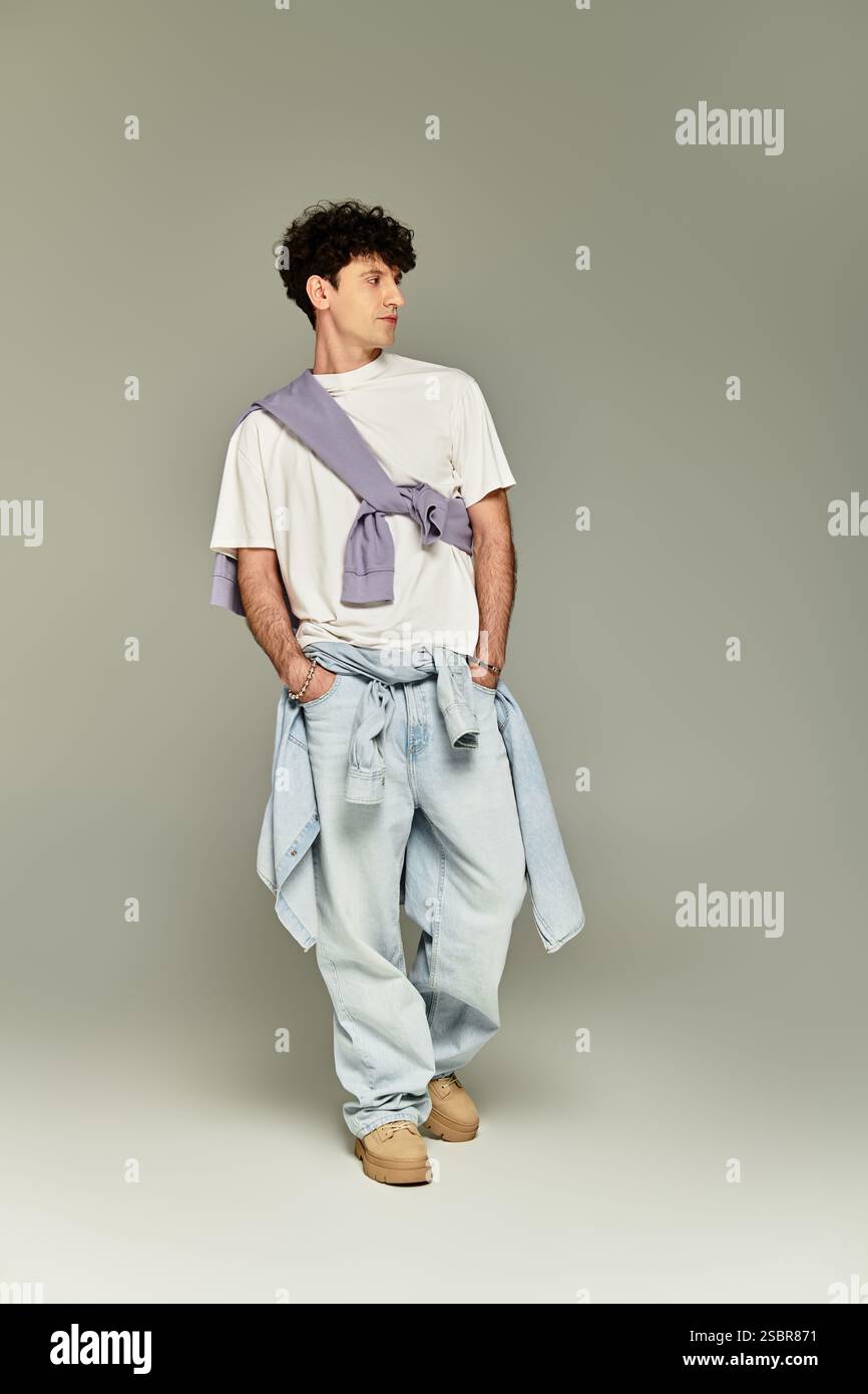 A young man showcases a fashionable and laid back look in a trendy ...