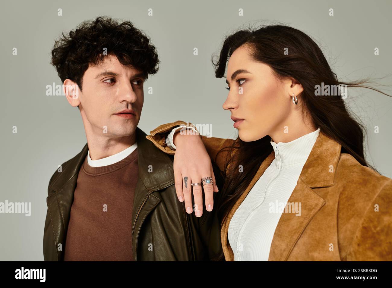 Fashionable duo showcases contemporary style while posing in a chic ...