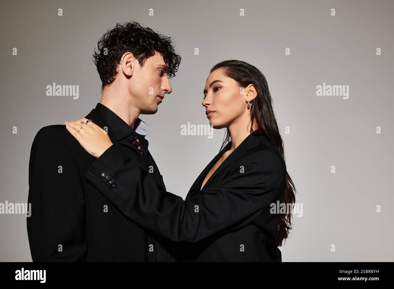 Two stylish young people connect in a lively pose, highlighting modern ...