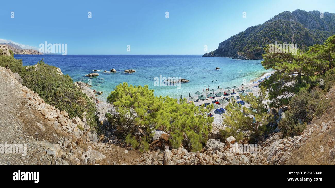 Overview of a beach scene at Apella beach with rocks and turquoise ...