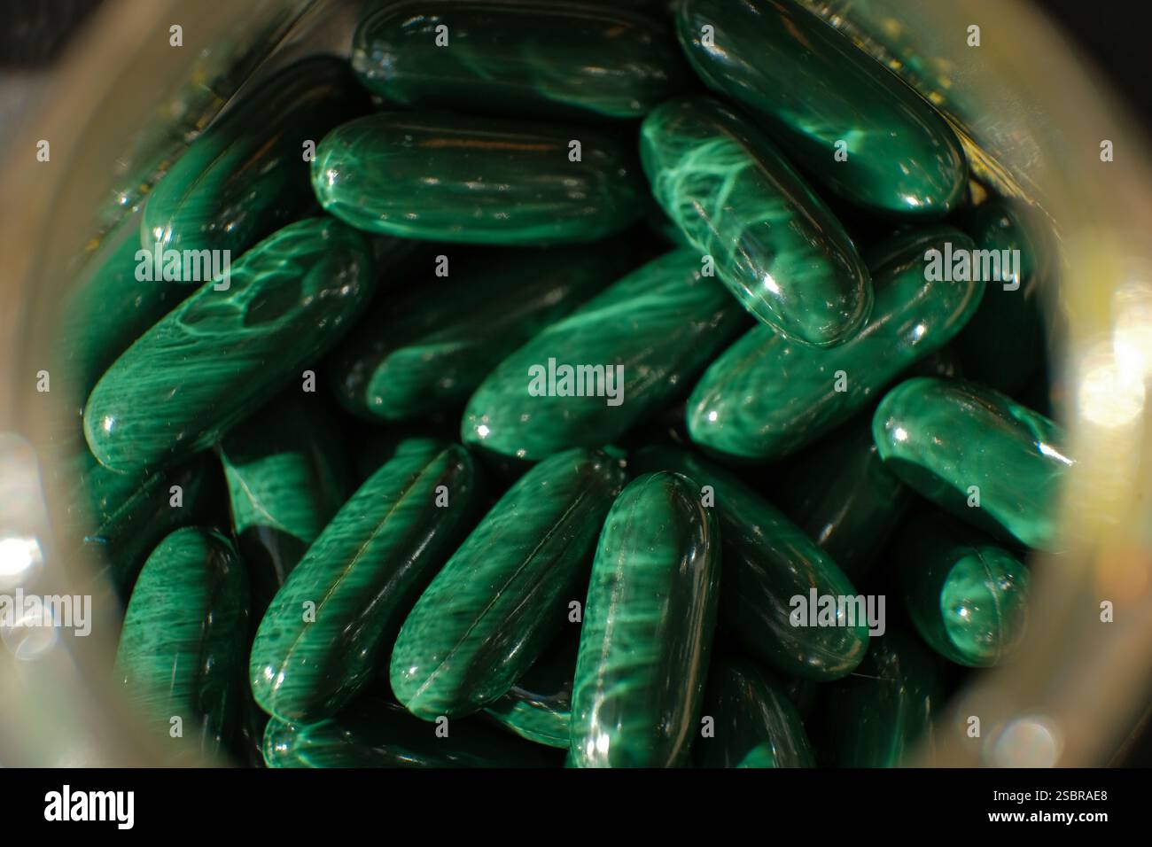 Macro view of green softgels with caustic sunlight shadows Stock Photo ...