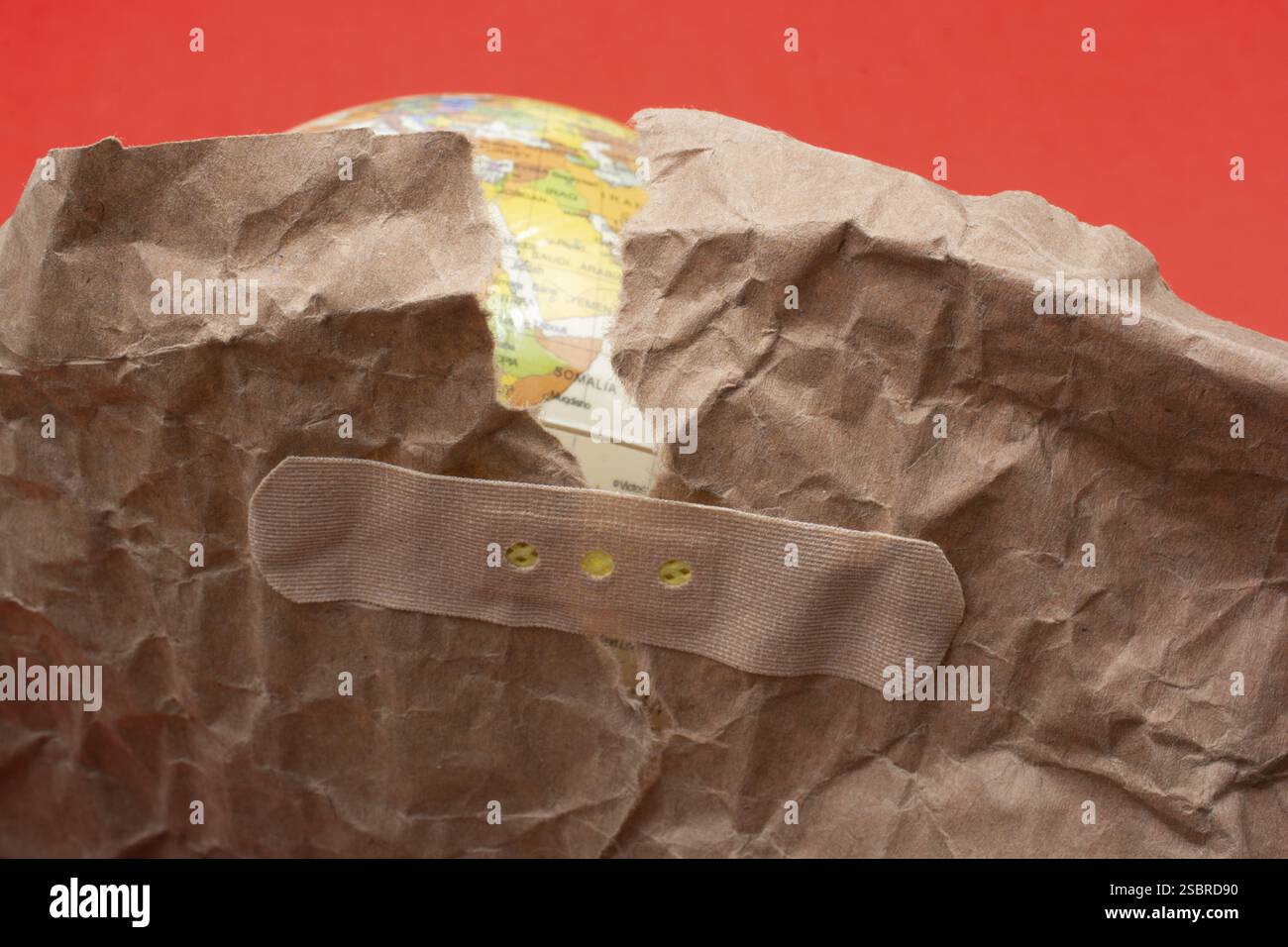 Earth with bandaided paper Solidarity and aid to countries in need ...