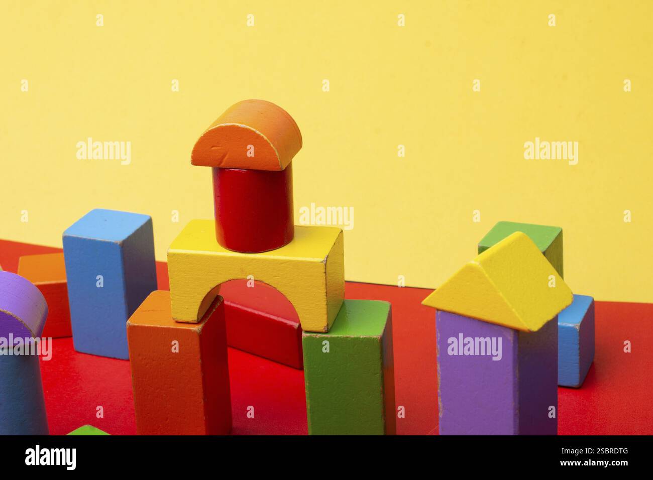 Different color and shape wooden toy building blocks Stock Photo - Alamy