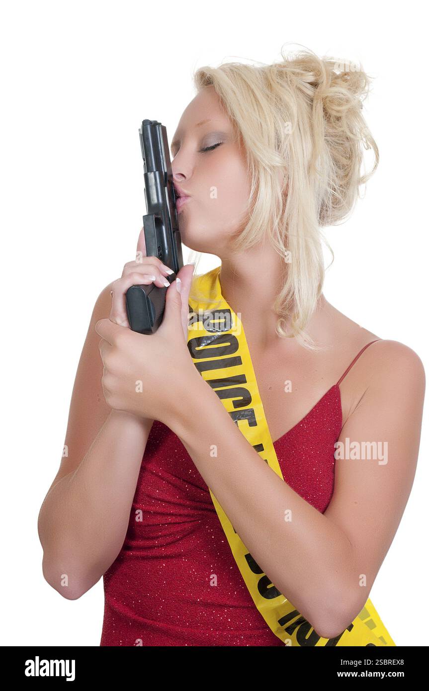 A beautiful police detective woman on the job kissing her gun Stock ...