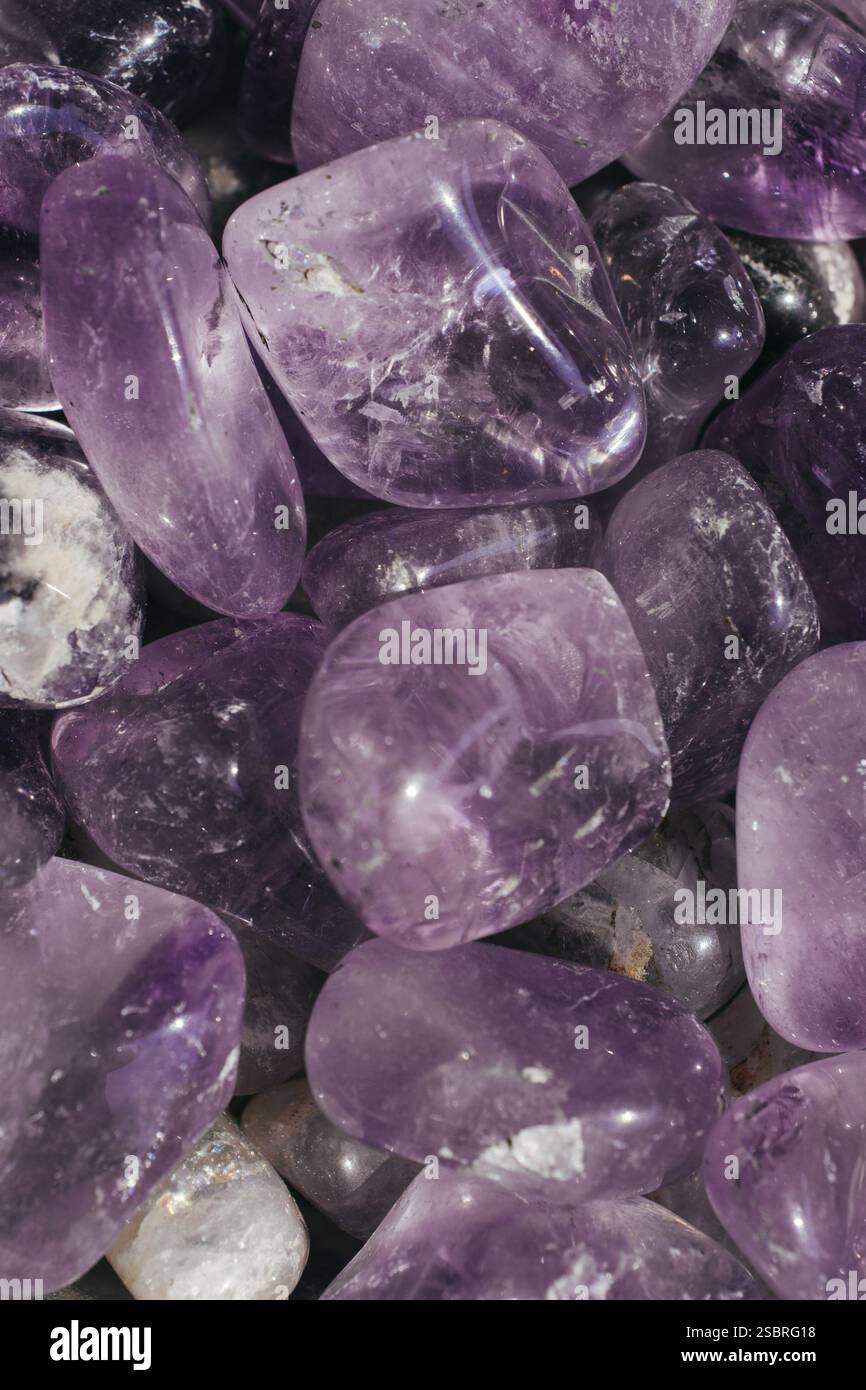 Tumbled Amethyst gem stone as mineral rock specimen Stock Photo - Alamy