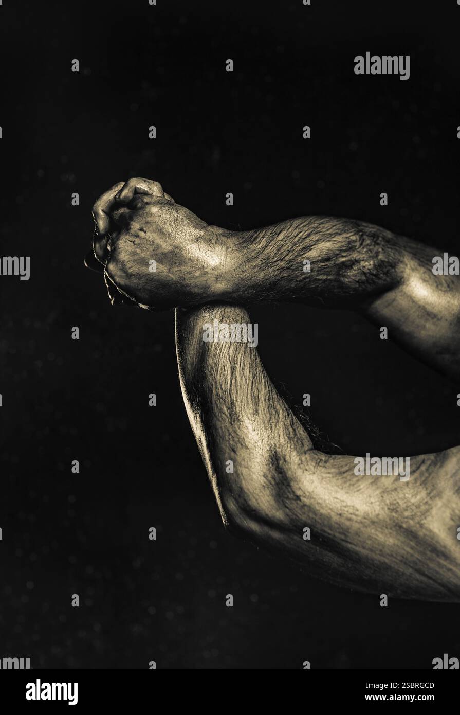 Close-up of a man's arm. Strong and power man's hand. Low key shoot ...