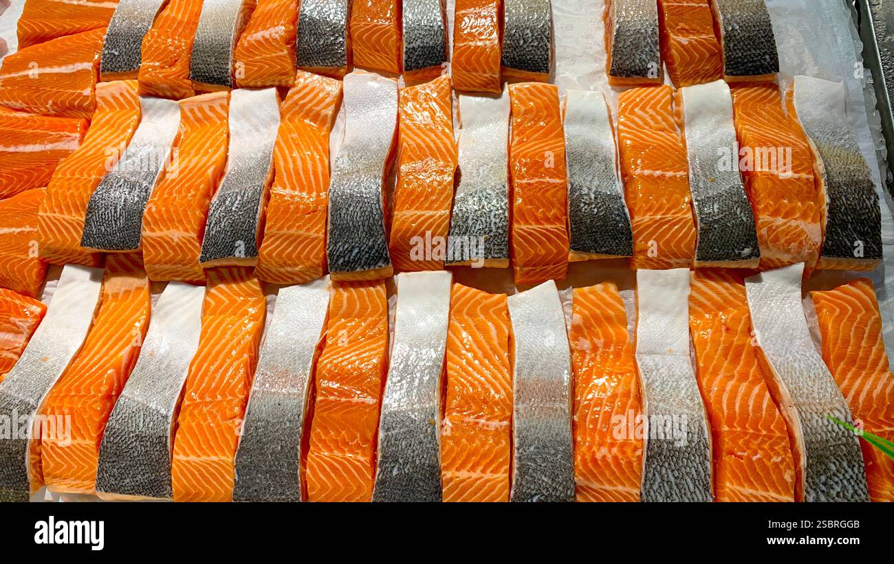 High angle view of slices of salmon fish display at market. Seafood ...