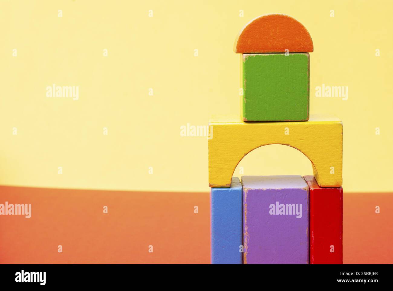 Different color and shape wooden toy building blocks Stock Photo - Alamy